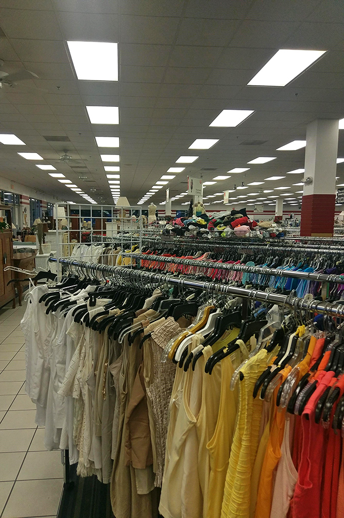 Color-coded clothing racks stretch toward the horizon like a textile rainbow. The thrill of the hunt is real when designer labels hide among everyday finds.