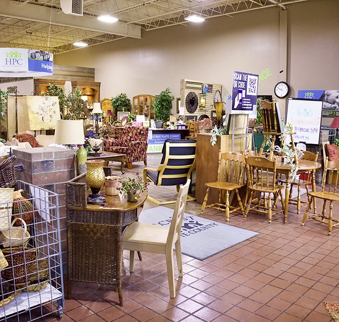 Wooden chairs and vintage furniture create an impromptu living room display, where yesterday's craftsmanship outshines today's assembly-required alternatives.