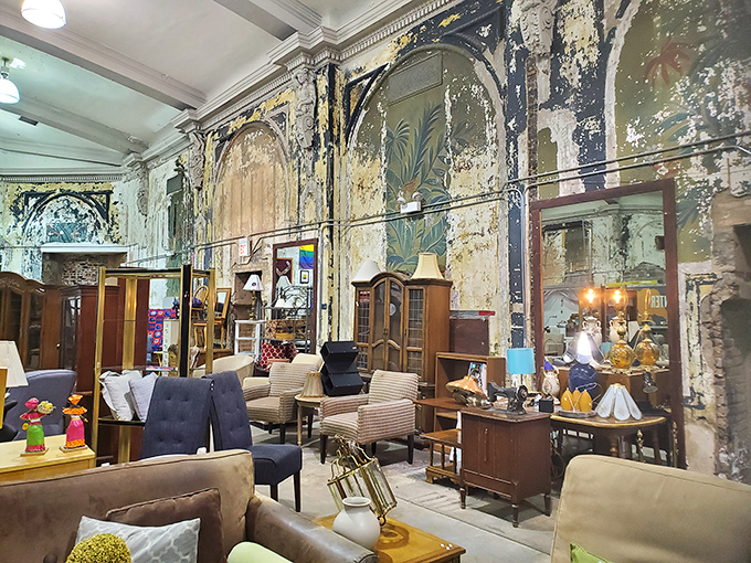 The weathered theater walls tell stories of their own, now serving as the perfect backdrop for mid-century treasures and vintage vibes.