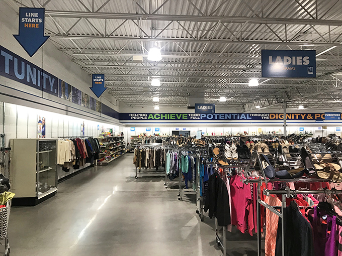 Helpful signage guides shoppers through this bargain wonderland. "Line starts here" is thrift-speak for "amazing finds ahead."
