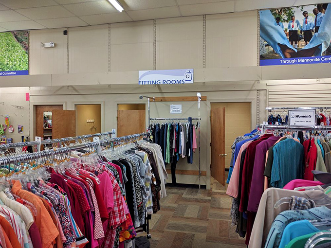 The fitting room area&mdash;that sacred space where thrift store optimism meets reality. "Please fit, please fit" is the silent prayer of bargain hunters everywhere.