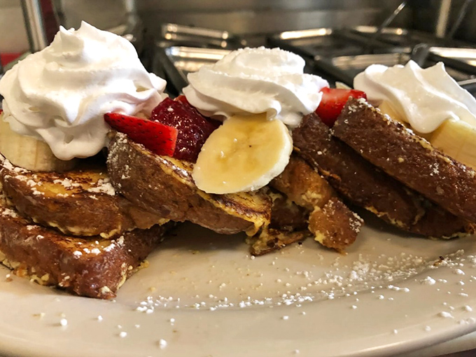 This isn't just French toast &ndash; it's a masterpiece of custard-soaked perfection topped with fresh fruit and whipped cream that would make Julia Child weep with joy.