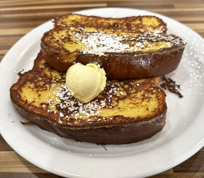 The star of the show: French toast dusted with powdered sugar and topped with butter that melts into every heavenly crevice.