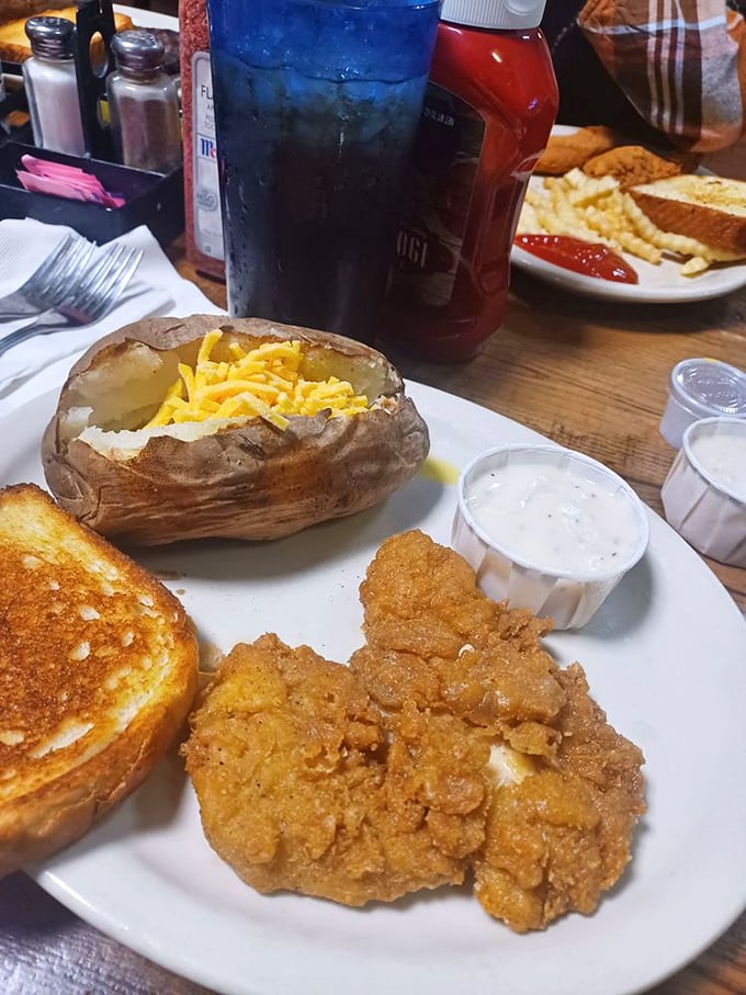 Golden-brown fried chicken that makes Colonel Sanders weep with jealousy, paired with a loaded baked potato that's practically a meal itself.