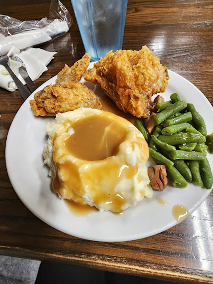 Fried chicken that achieves the holy trinity of buffet perfection: golden-crisp exterior, juicy interior, and a gravy lake of mashed potatoes for dunking.
