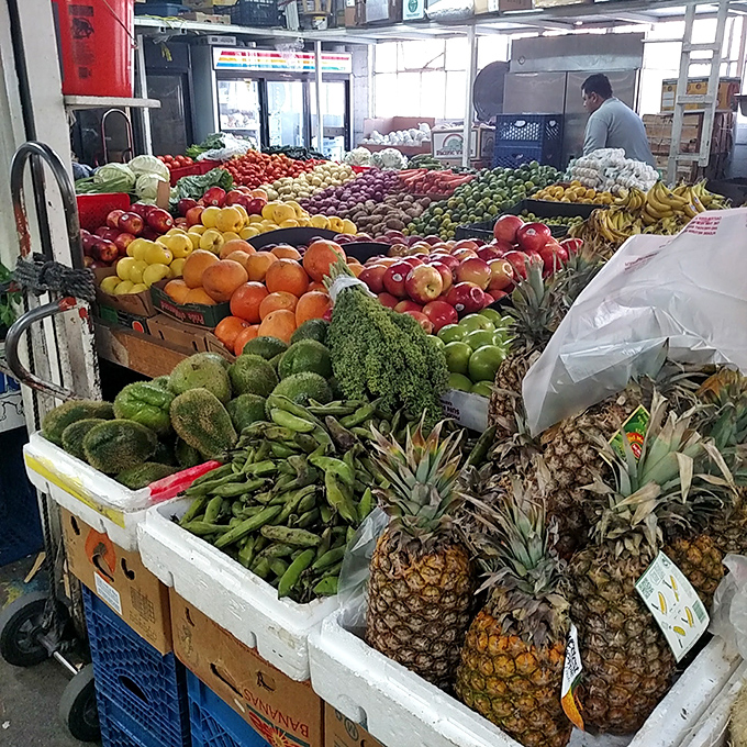 Nature's candy store! Pineapples, avocados, and mangoes stacked with military precision&mdash;the produce section Michelangelo would have painted.