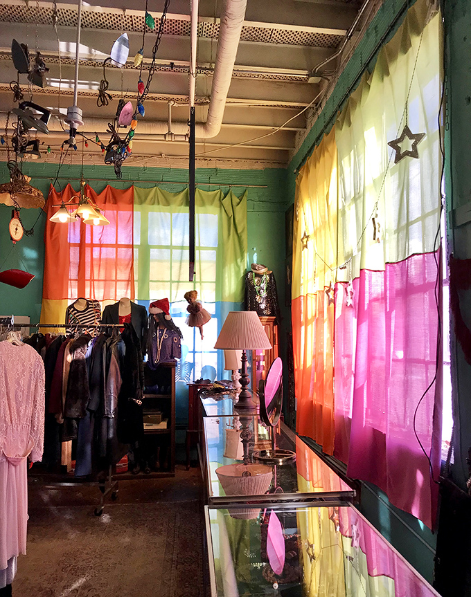 Rainbow curtains filter sunlight like stained glass in this vintage clothing corner. At The Zenith, even shopping becomes part of the dining experience.