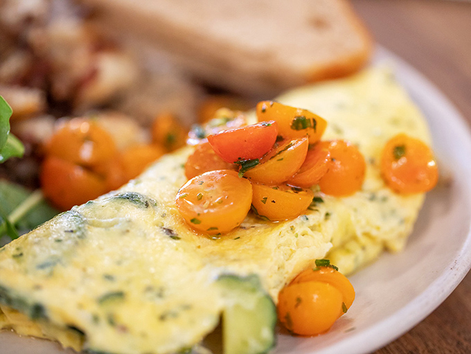 The omelet of your dreams doesn't exi&mdash; Oh wait, here it is. Fluffy eggs cradle fresh vegetables topped with cherry tomatoes that burst with sunshine in every bite.