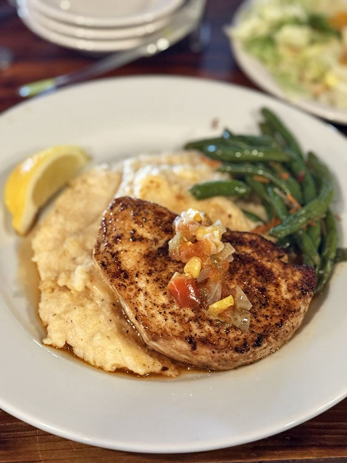 This blackened fish perched atop creamy grits isn't just dinner &ndash; it's the Gulf Coast's greatest hits album on a plate.