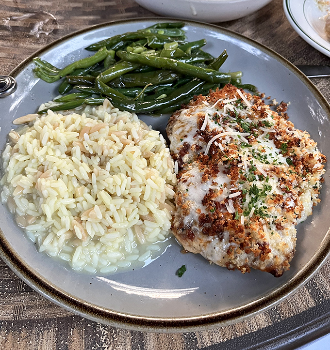 Behold the famous grouper that launches road trips! Perfectly seared, resting on rice pilaf with green beans&mdash;a plate that proves Missouri knows seafood.