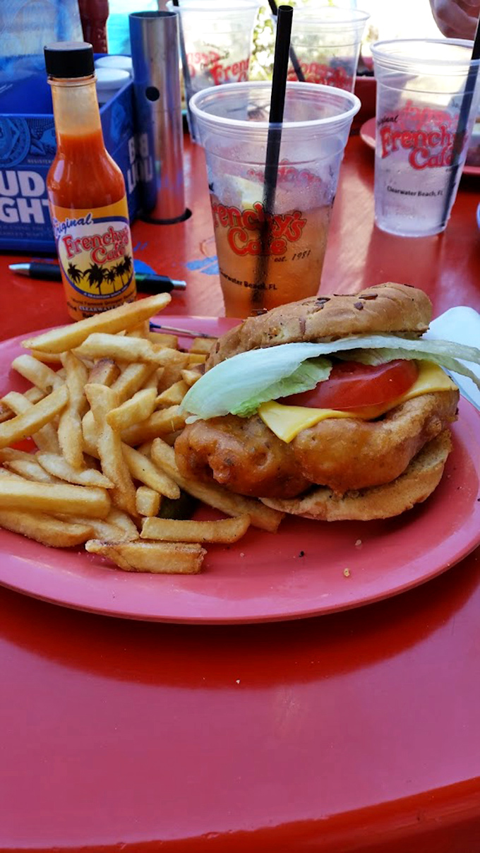 Behold the star of the show! This golden-fried grouper sandwich with crisp lettuce and tomato might just be worth planning your entire vacation around.