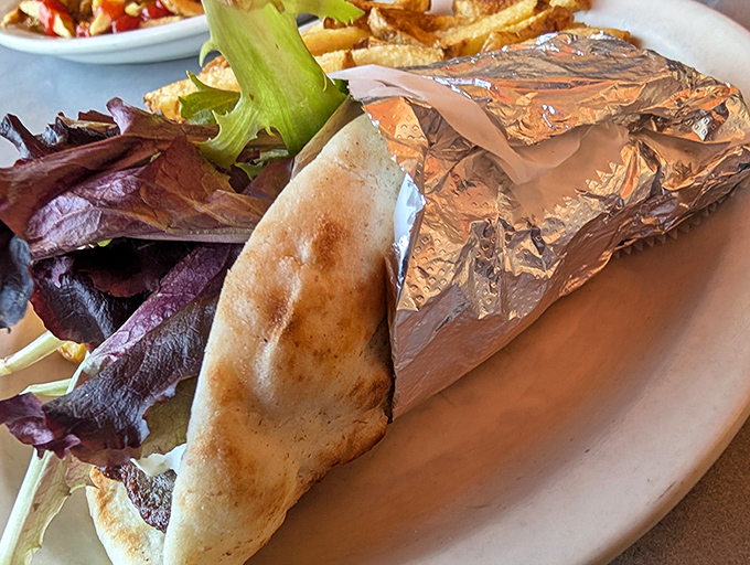 This isn't just a gyro&mdash;it's a Mediterranean vacation wrapped in foil, with crisp lettuce providing the perfect contrast to seasoned meat.