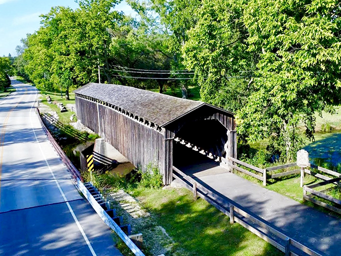 Wisconsin's last remaining covered bridge spans Cedar Creek like a wooden sentinel, protecting travelers just as it has since 1876.