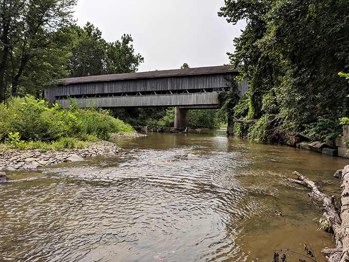 This covered bridge doesn't just span Conneaut Creek&mdash;it connects generations. Fishermen below hope for steelhead while the structure whispers 19th-century secrets.