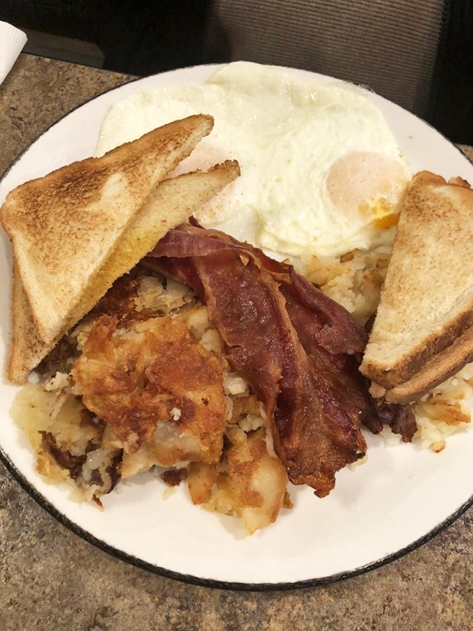 Behold the holy trinity of breakfast: perfectly cooked eggs, crispy home fries, and toast that's actually toasted properly. Simple pleasures executed flawlessly.