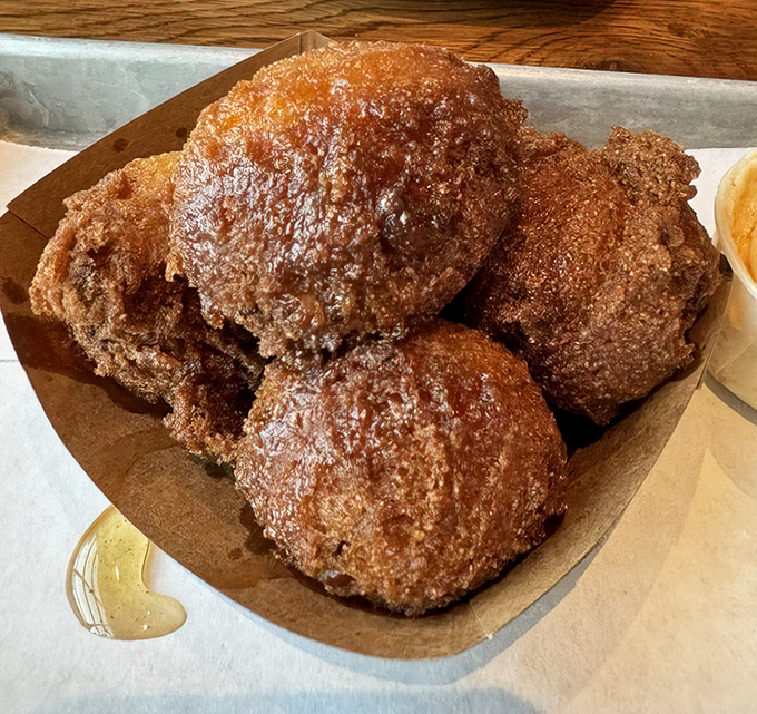 These aren't just hush puppies&mdash;they're golden orbs of cornmeal perfection. Crispy exterior, fluffy interior, and enough flavor to make you contemplate ordering seconds before finishing firsts.