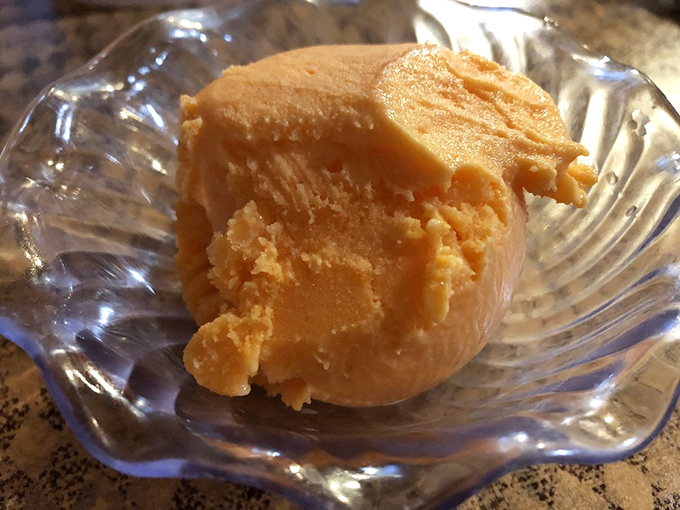 This unassuming scoop of orange ice cream might not win any beauty contests, but one taste and you'll understand why locals drive miles for this creamy, homemade treasure.