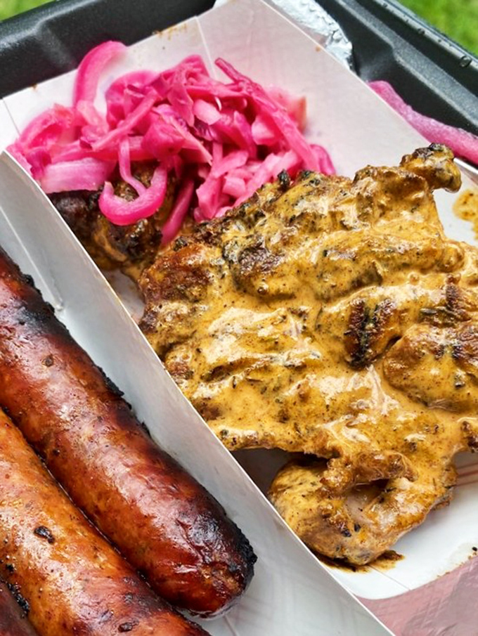 Jerk chicken so good it should require ID. Those vibrant pink pickled onions cut through the richness like a well-timed punchline after a long story.
