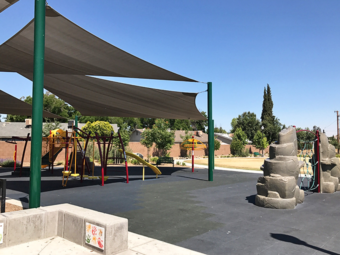 This playground offers shade in summer's heat and memories year-round, proving paradise doesn't need an ocean view to feel like heaven.