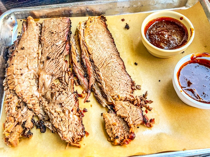 Behold the holy grail: perfectly sliced brisket with that coveted pink smoke ring showing off.