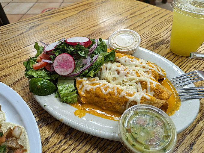 These aren't just enchiladas; they're flavor vessels sailing on a sea of rich sauce, with that fresh salad providing the perfect crisp counterpoint.