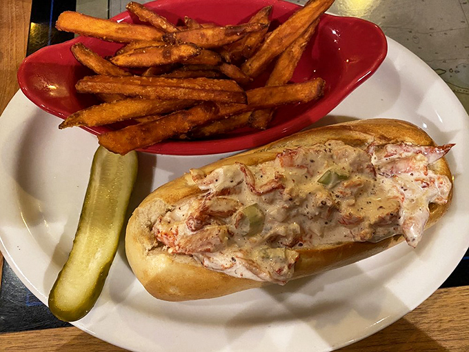 This lobster roll isn't just a sandwich—it's a celebration. Sweet chunks of lobster meat nestled in a perfect bun with those golden fries standing guard.