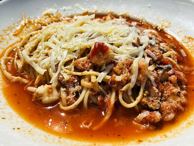 This isn't just pasta; it's a Mediterranean symphony where tomato, seafood, and cheese perform a three-act opera on your palate.