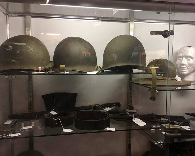 Military helmets stand at attention, silent witnesses to history that speak volumes to collectors who appreciate their solemn significance.