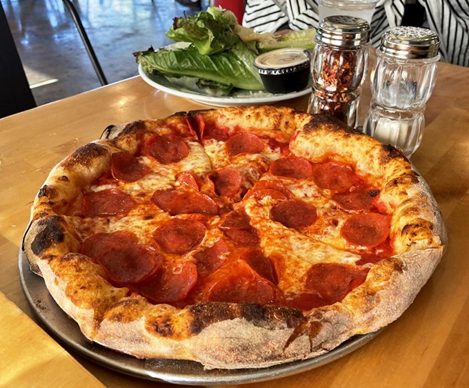 This isn't just pizza&mdash;it's a wood-fired canvas where pepperoni gets the smoky treatment usually reserved for brisket. Crispy, chewy, perfect.