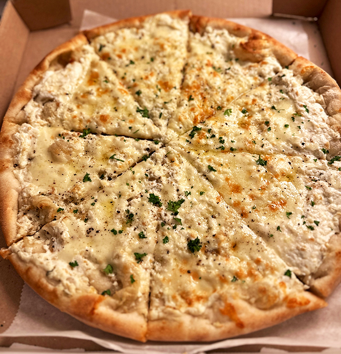 Behold the white pizza in all its glory&mdash;a canvas of perfectly melted cheese sprinkled with herbs that whisper, "Take a picture first, but hurry up and eat me."