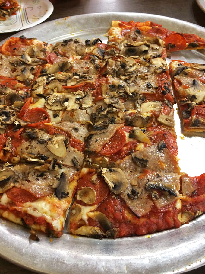 The holy trinity of pizza perfection: thin cracker-like crust, perfectly seasoned sauce, and toppings that know their role in this delicious drama.