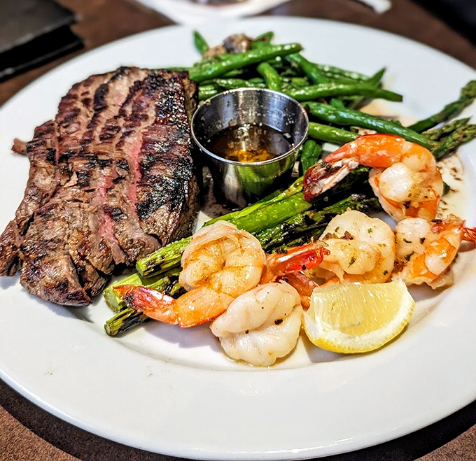 Surf and turf perfection: A perfectly seared steak alongside plump shrimp and asparagus. This isn't a meal, it's a celebration.