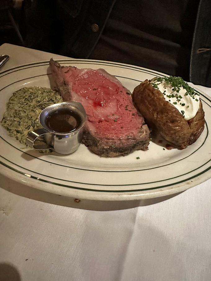 Behold the star of the show: prime rib so perfectly pink it should have its own Instagram account, flanked by creamed spinach and a loaded baked potato.