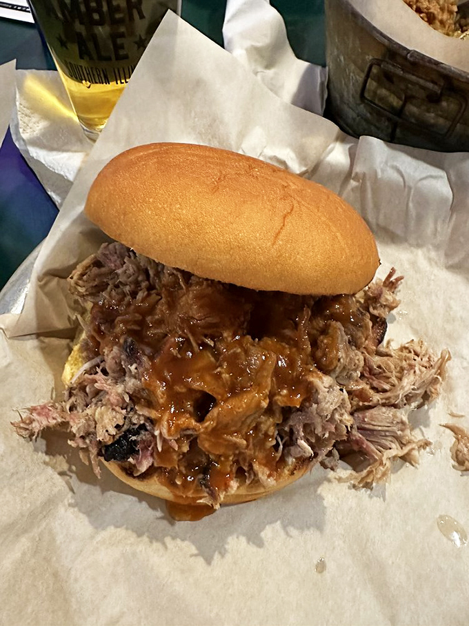 This isn't just a sandwich; it's a monument to patience. Pulled pork so tender it practically surrendered to the fork before meeting that lucky bun.