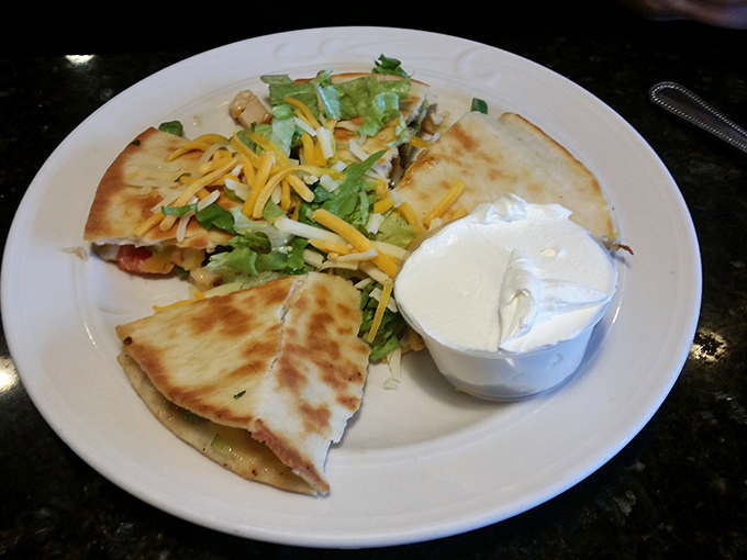 Golden quesadillas arrive like edible sunshine, promising melted cheese happiness in every perfectly crispy bite.