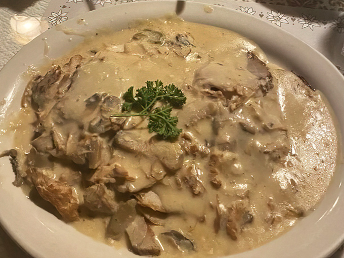 Rahmschnitzel swimming in mushroom cream sauce that would make your cardiologist wince but your taste buds sing arias of joy.