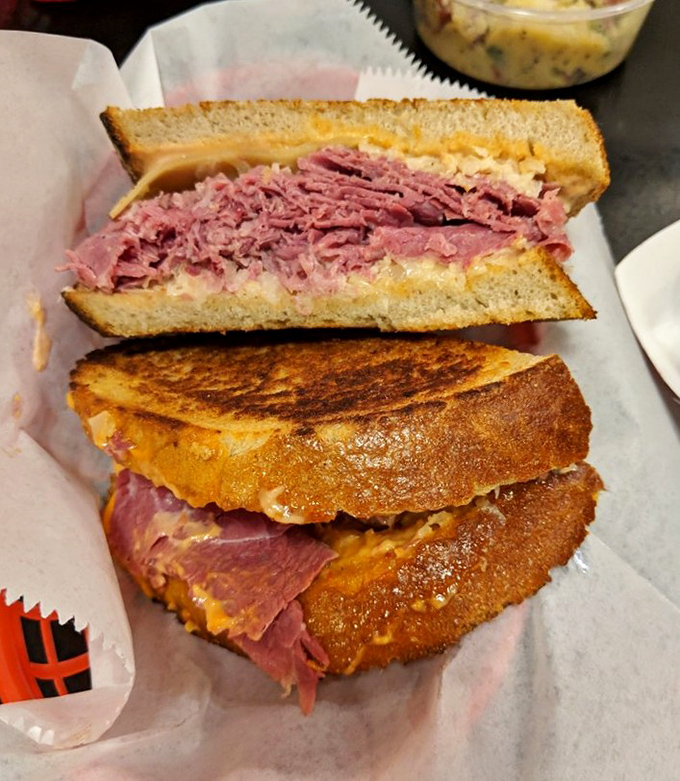 Behold the mighty Reuben in its natural habitat! Corned beef stacked higher than your expectations, melty Swiss, and that perfect grilled rye.