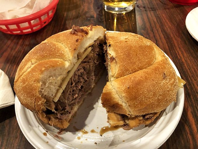 The star of the show in all its glory&mdash;tender roast beef piled generously on a perfect roll, ready for its au jus bath. Food poetry on a plate.