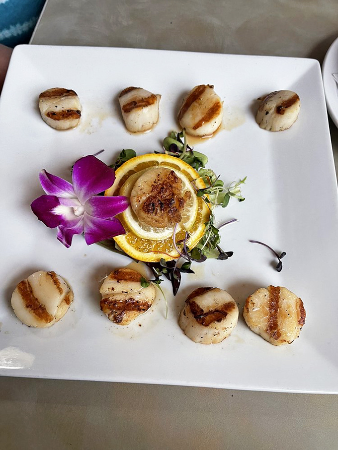 These scallops aren't just seared, they're transformed&mdash;arranged like a delicious clock of oceanic perfection with that orchid adding a tropical exclamation point.