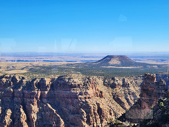 Beyond the rim lies a landscape so vast and colorful, it makes your smartphone camera weep with inadequacy.