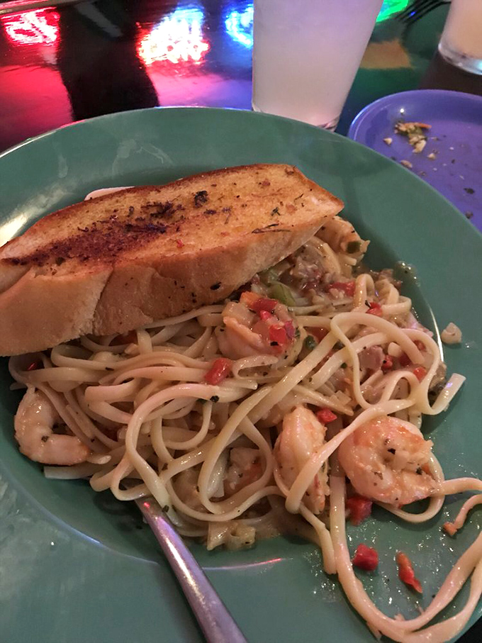 Shrimp scampi that demands your attention&mdash;plump crustaceans lounging in pasta like they're on vacation, with garlic bread standing by for essential sauce-sopping duties.
