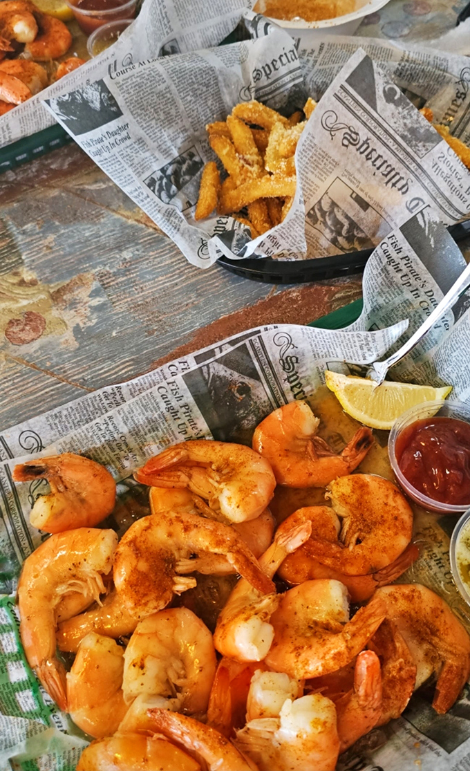 These peel-and-eat shrimp aren't just seafood – they're an interactive culinary adventure served on a newspaper tablecloth that tells stories of its own.