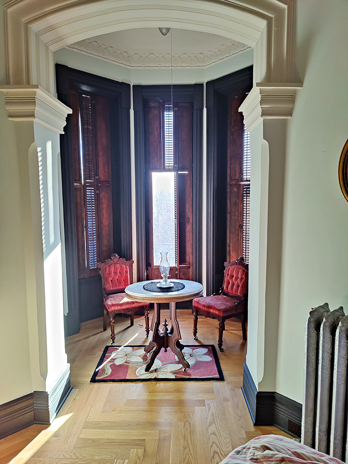 A perfectly staged Victorian sitting area where you half-expect to see a ghost sipping tea. Those curved windows were architectural showpieces in their day.
