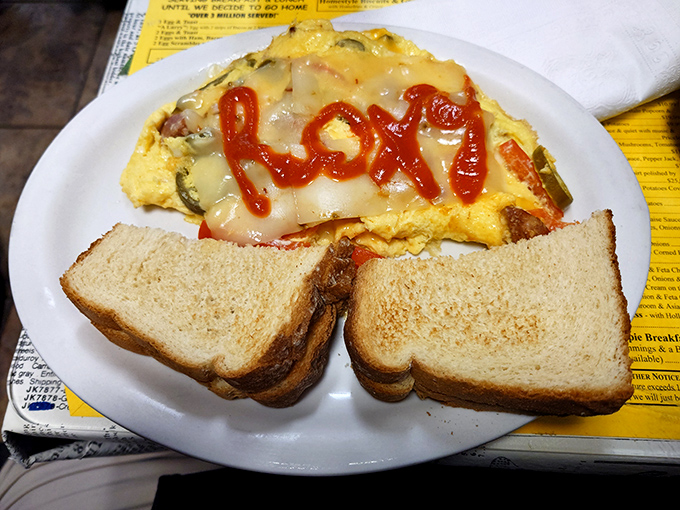 Breakfast artistry at its finest&mdash;an omelet personalized with the restaurant's name in ketchup. When your food knows who's serving it, you're in the right place.