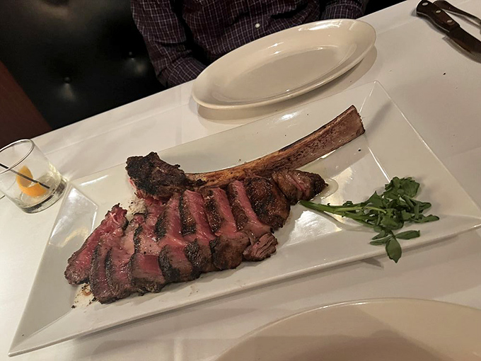 Behold the tomahawk ribeye in its natural habitat. That bone isn't just for show—it's nature's handle for the carnivorous masterpiece before you.