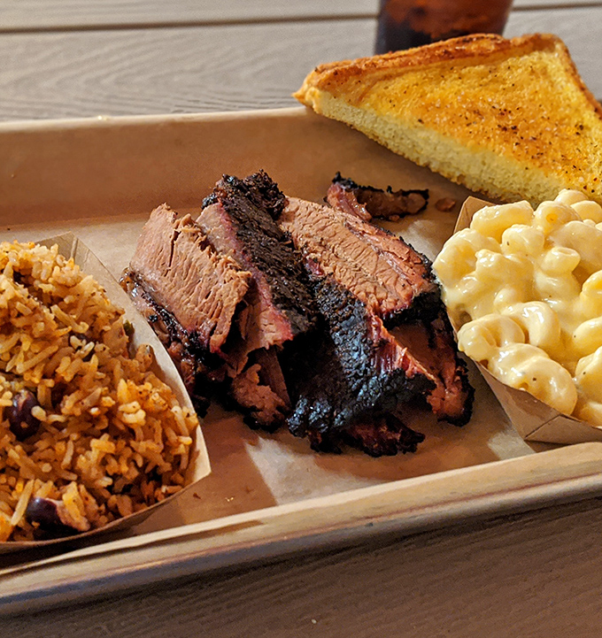 Brisket that doesn't just melt in your mouth but makes time stand still. The smoke ring is so perfect it could be framed in a museum of meat artistry.