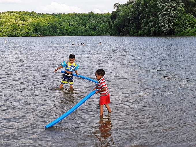 Childhood joy in its purest form&mdash;two kids turning pool noodles into instruments of imagination at Salt Fork's welcoming shoreline.