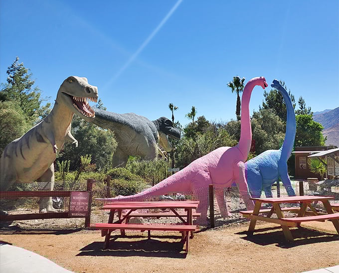 Picnic among the predators! These cheerful tables offer the perfect spot for a lunch break while surrounded by Jurassic giants.