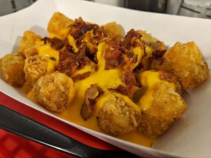 Golden-brown tater tots wearing a melty cheese jacket with bacon confetti. If potatoes have an afterlife, this is what they aspire to become.