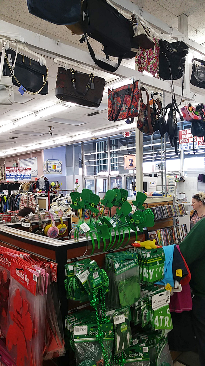 Handbags dangle like exotic fruit from the ceiling, a fashion forest where designer labels hide among everyday offerings.